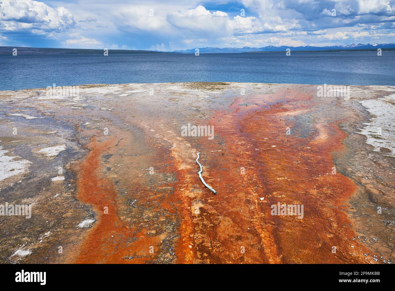 Yellowstone Park Lake with colorful earth in front Stock Photo - Alamy