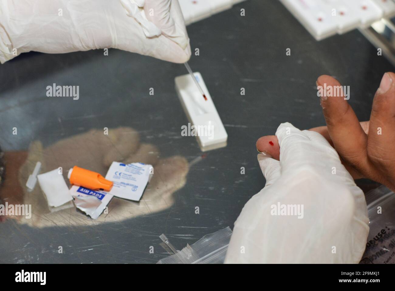 a medical personnel making a rapid test of virus c for a patient ...