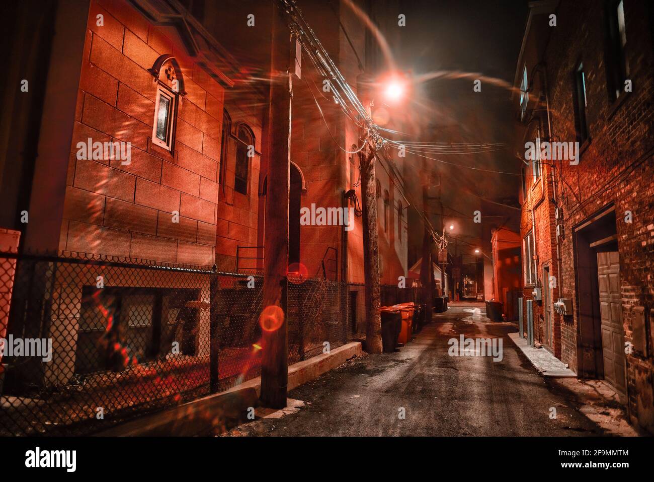 Dark and eerie urban city alley at night Stock Photo - Alamy