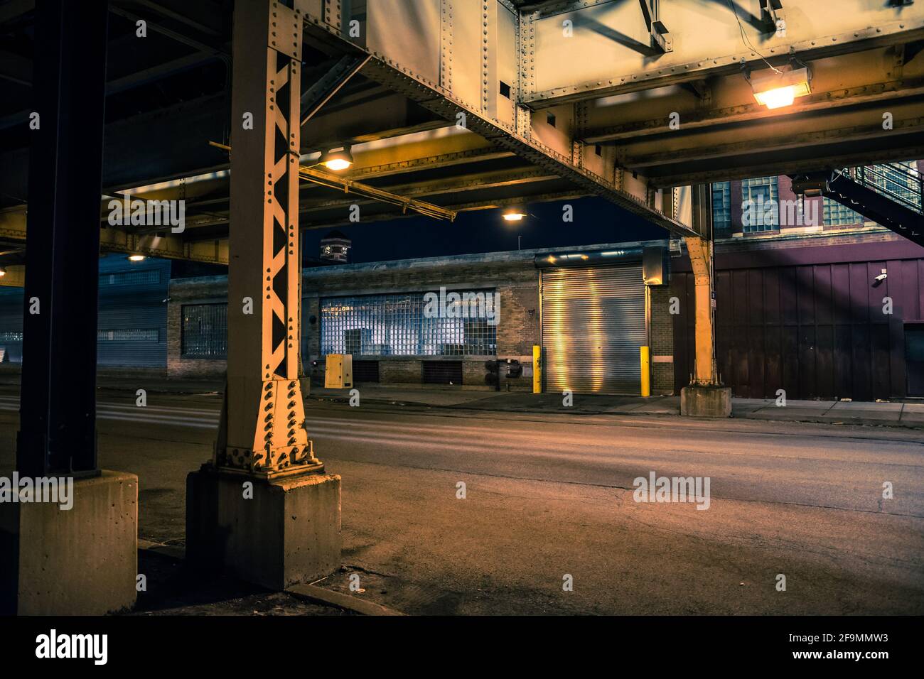 Dark and eerie Chicago urban city street night scenery with elevated ...