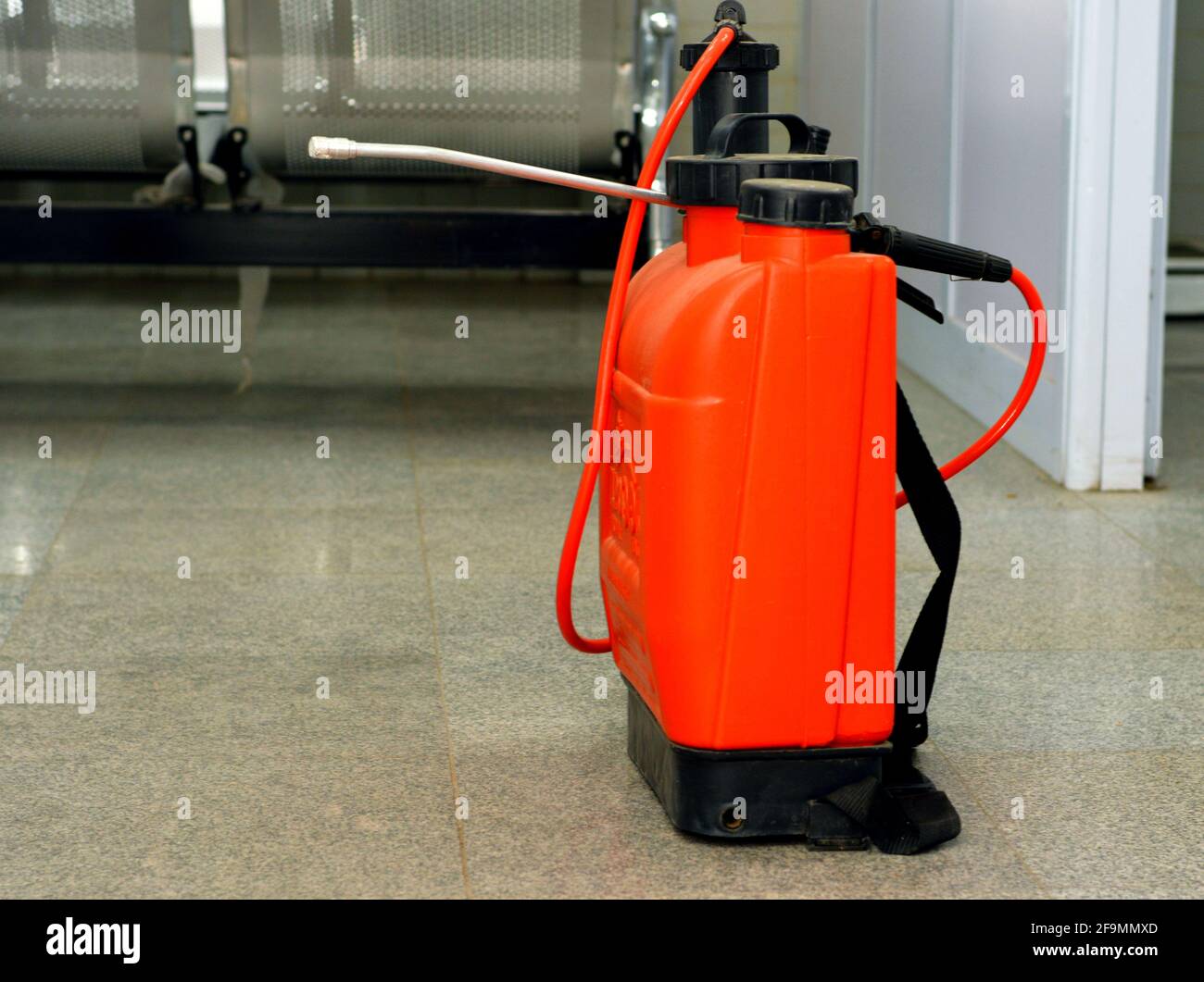 A side view of a back support disinfection sprayer container that ...