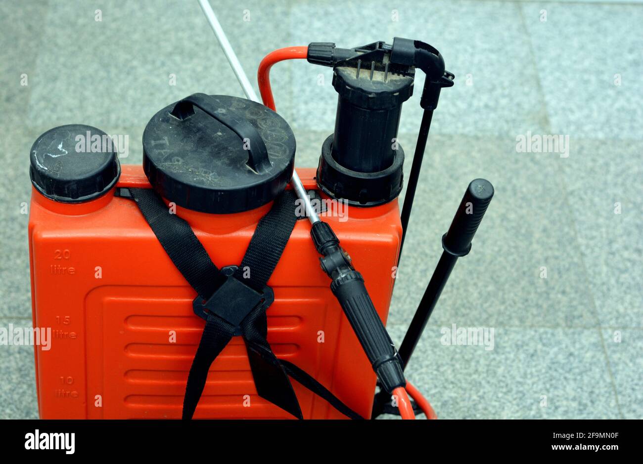 A side view of a back support disinfection sprayer container that ...