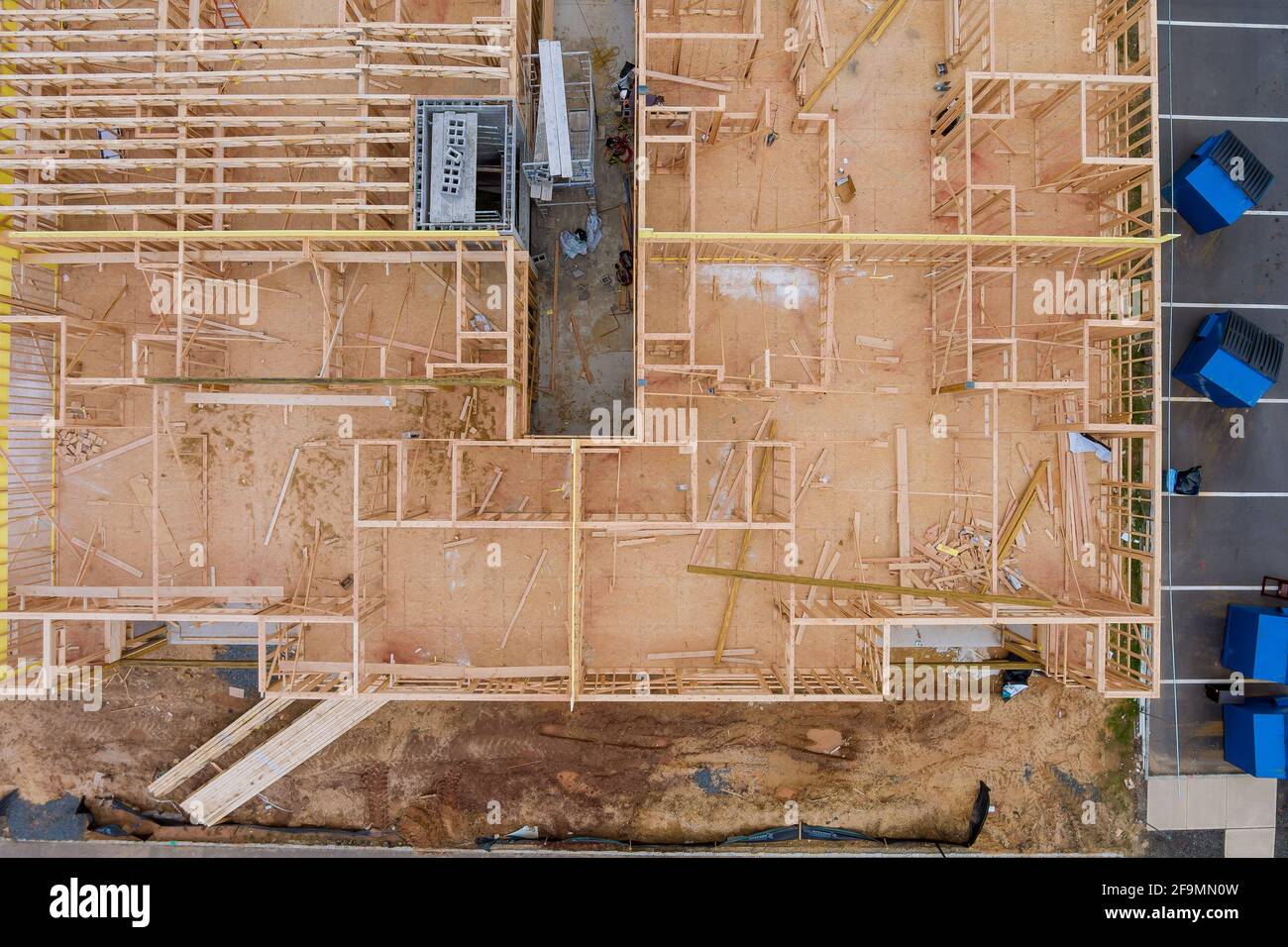 Aerial view of masonry brick builders are building walls in elevator ...
