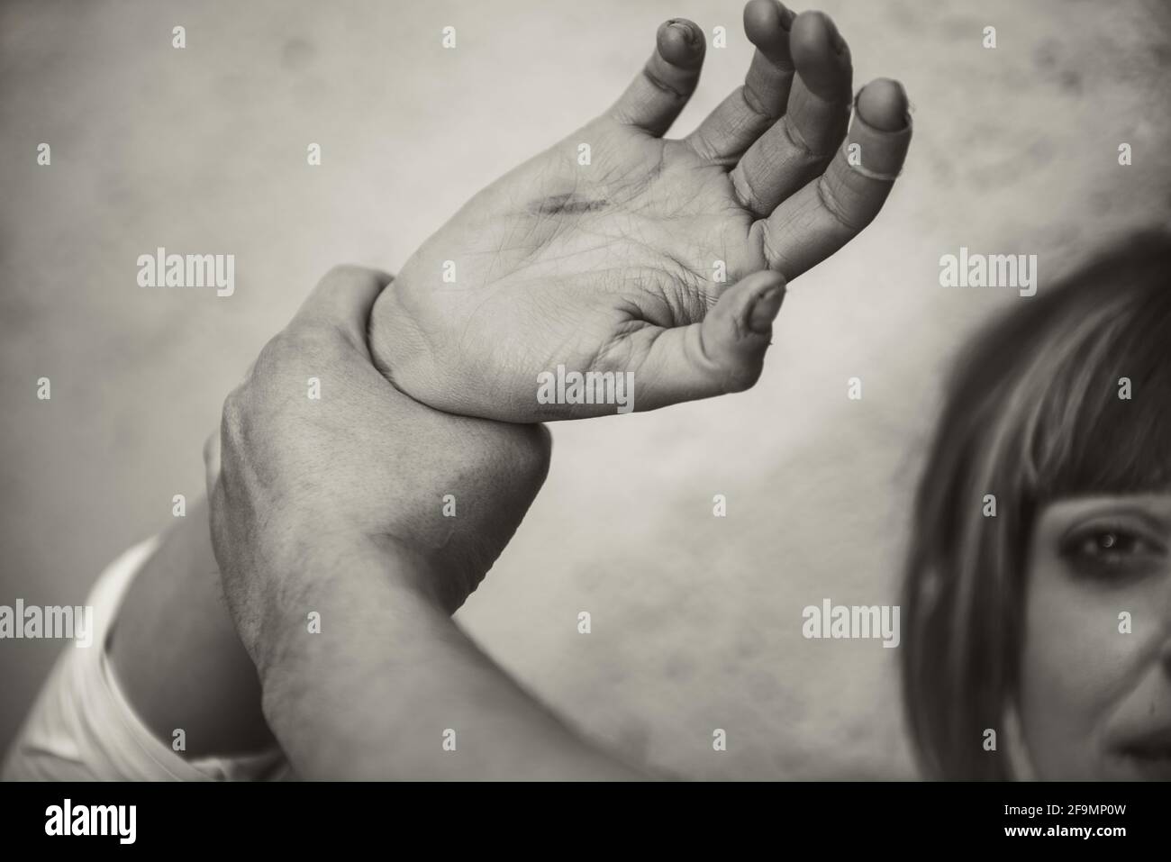 Close-up to the woman and her desperate face, the man’s hand closing ...