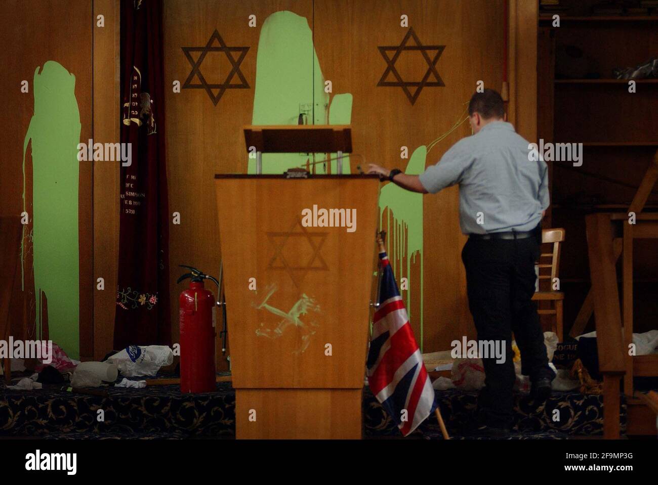 A SECURITY GUARD SURVEYS THE DAMAGE TO A NORTH LONDON SYNAGOGUE. 29/4 ...