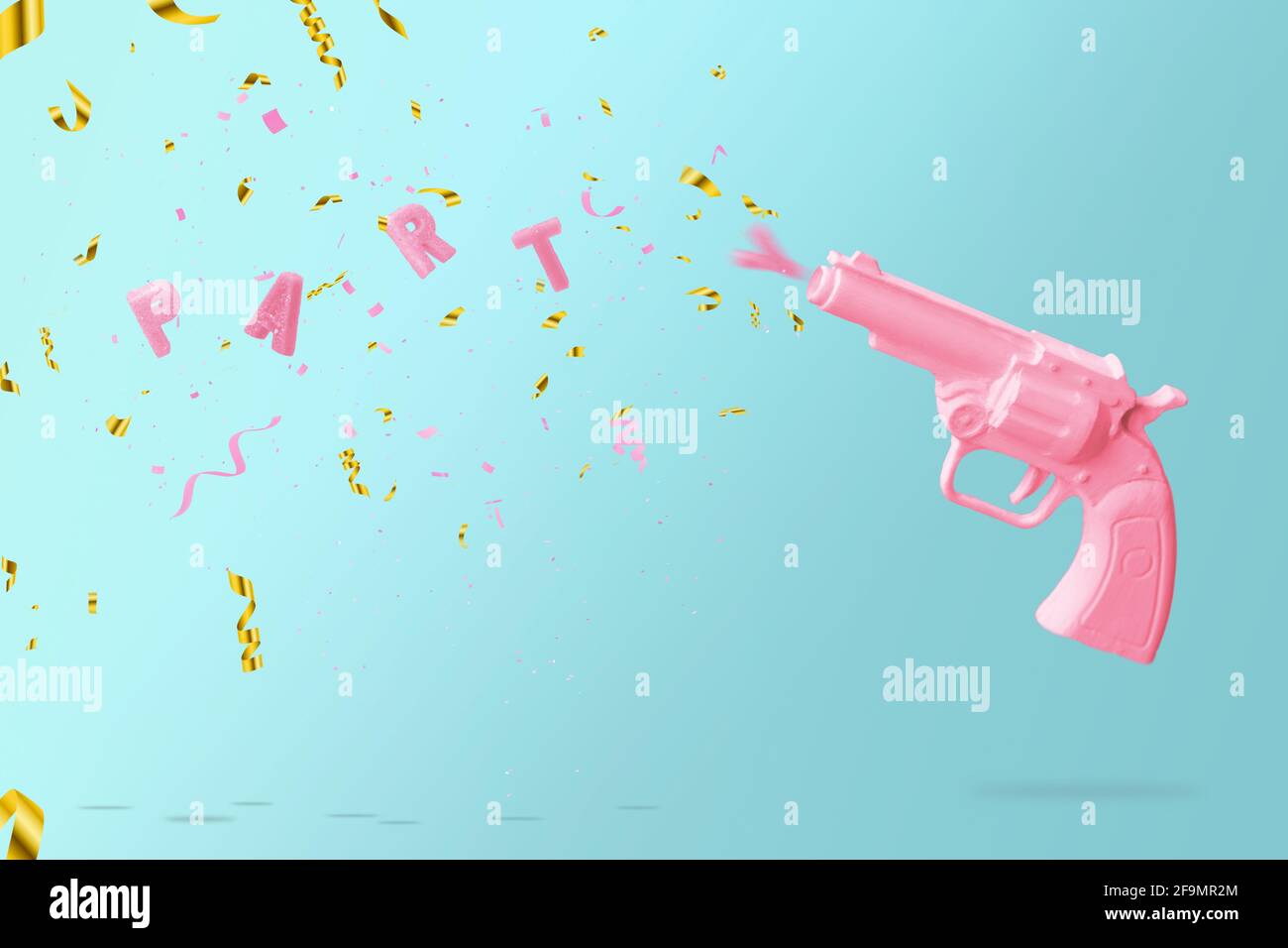Pink gun shooting birthday candles writing word Party, against blue ...