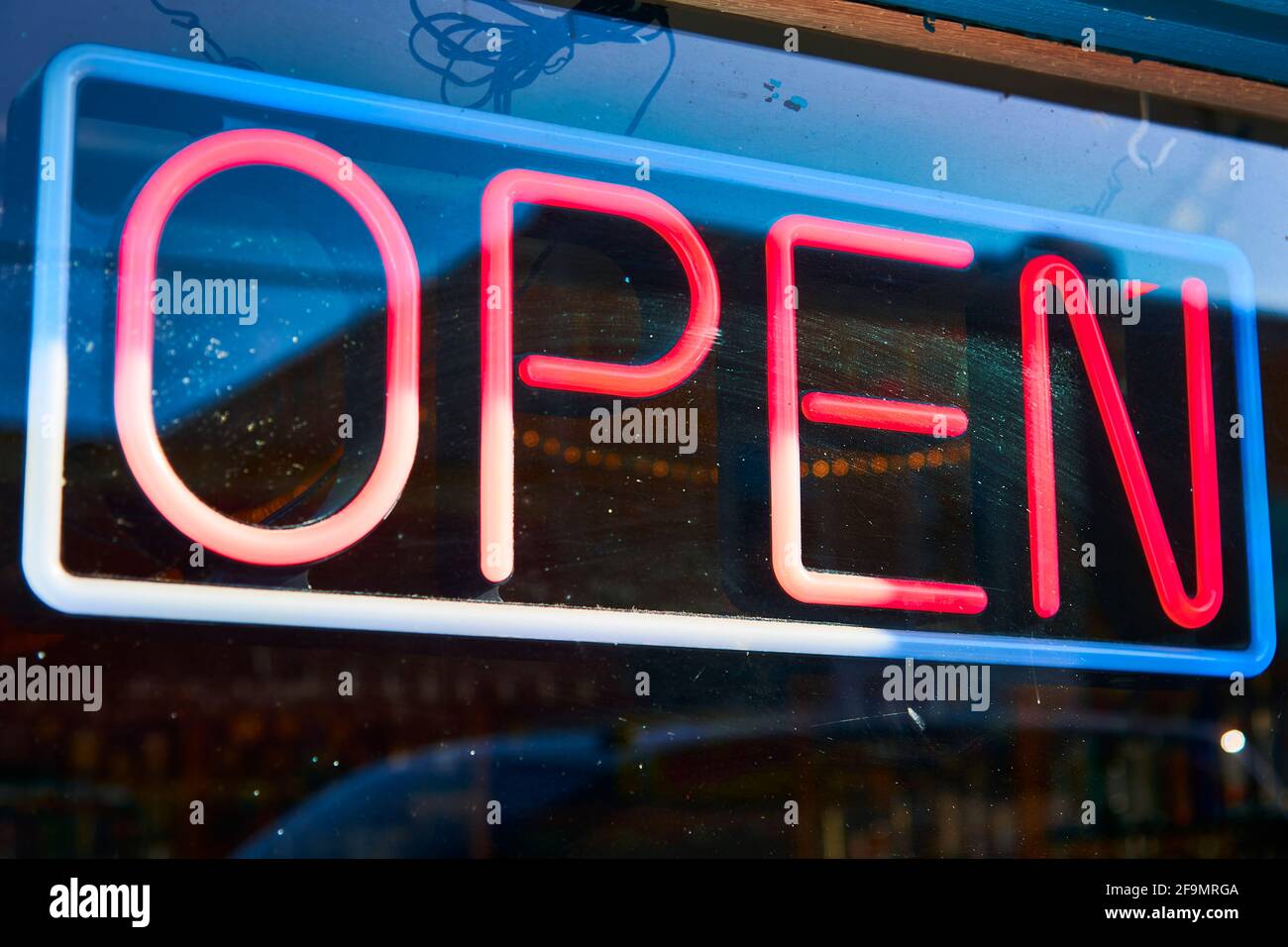 Flashing Blue and red neon sign open in window Stock Photo - Alamy