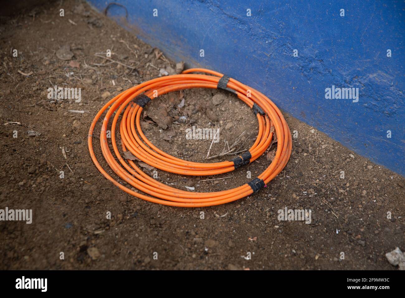 Device for modern fiber optic cables lies on the floor of a house wall ...