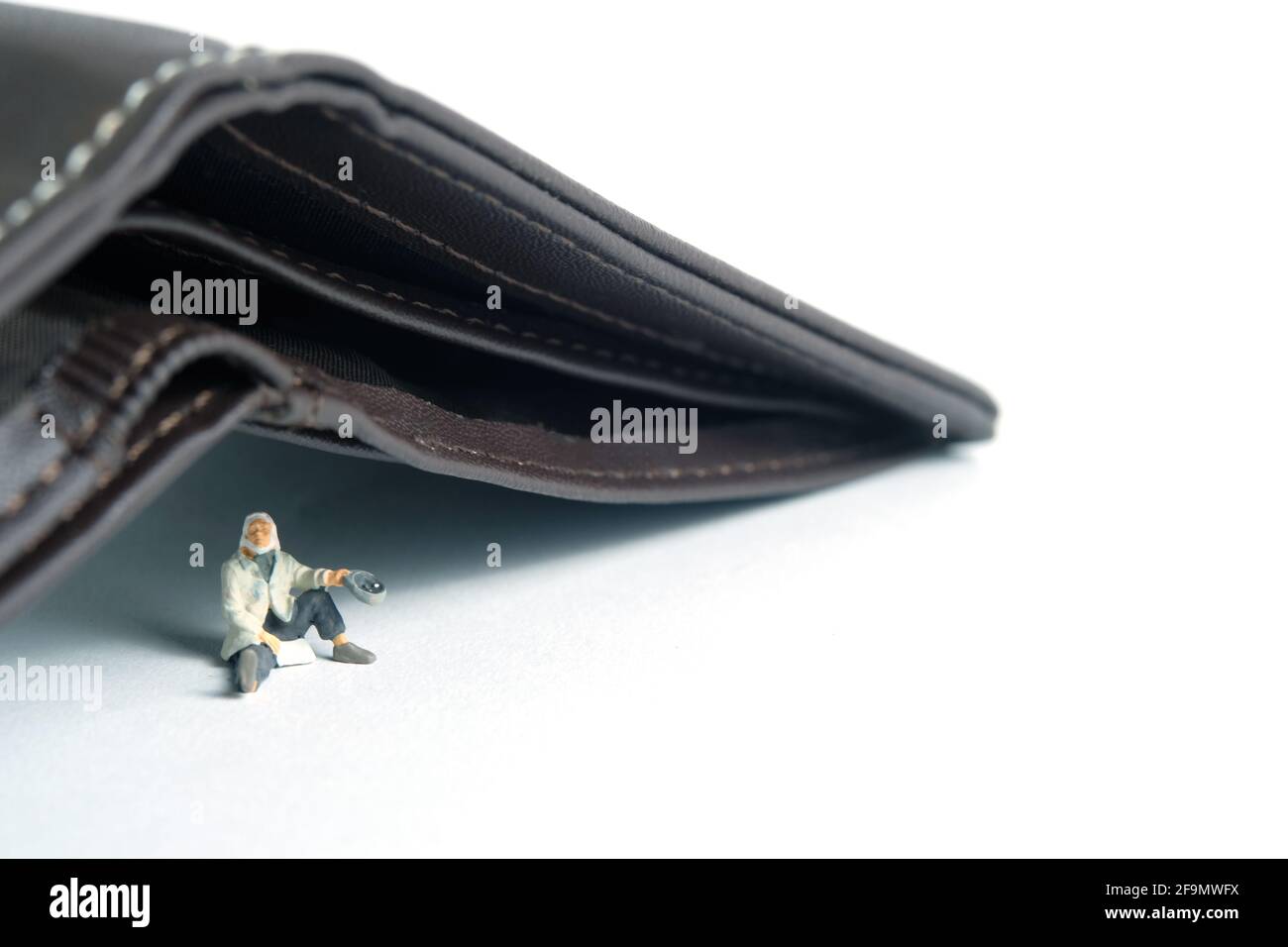 Poor man beggar with empty wallet no money cash. Miniature tiny people ...