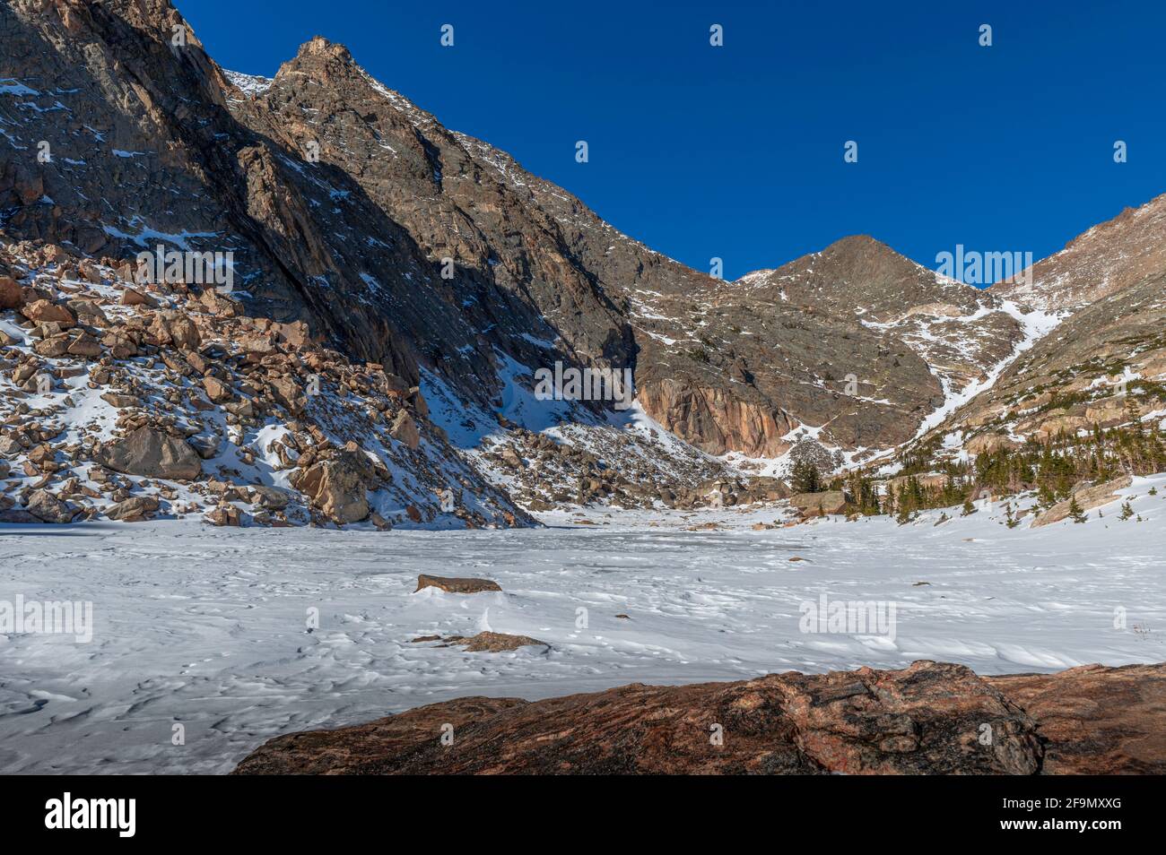 The jagged peaks of Ypsilon Mountain tower over Upper Fay Lake Stock ...