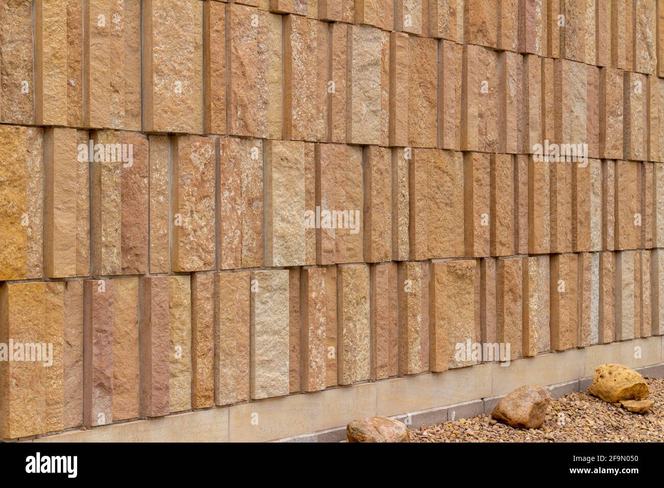 Modern rough textured limestone wall with vertical aligned natural ...