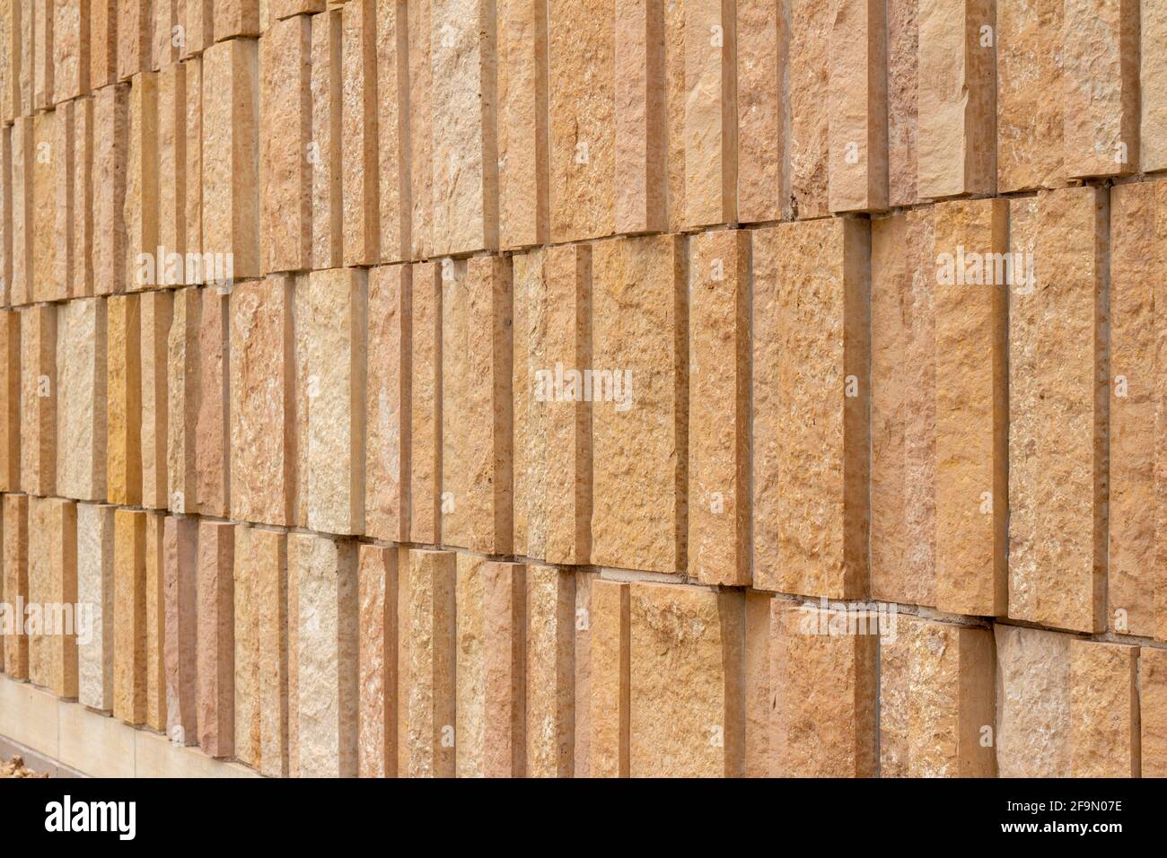 Modern rough textured limestone wall background with attractive ...