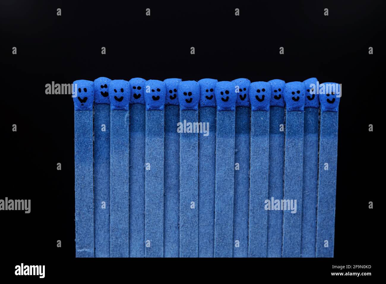 blue matchsticks with faces painted on the heads Stock Photo - Alamy