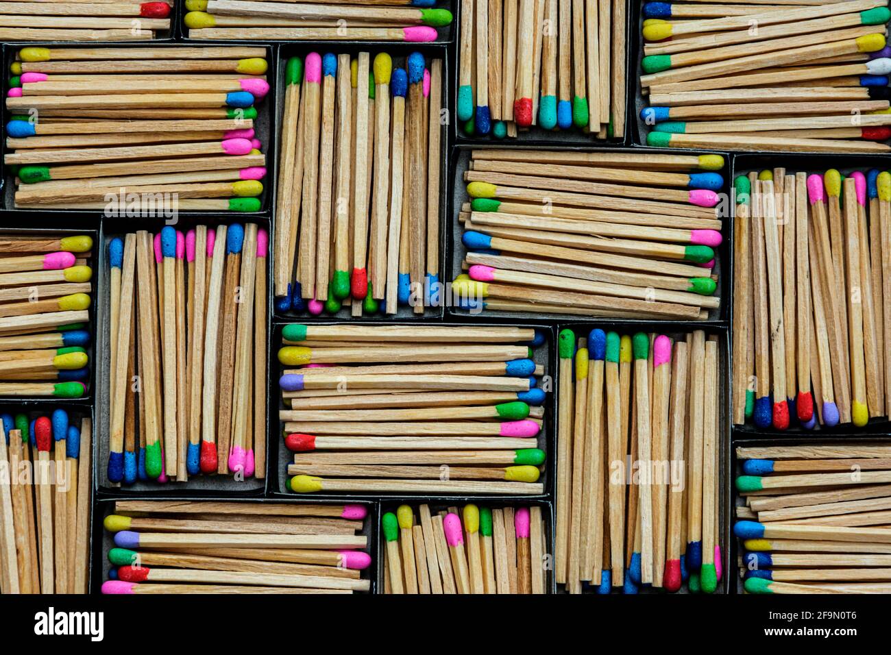 multicolored match sticks in boxes on a black background Stock Photo ...