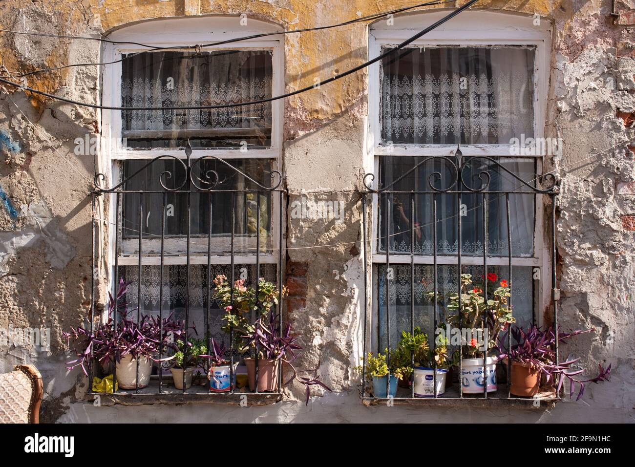 Amazing colorful flowers around the windows Stock Photo - Alamy