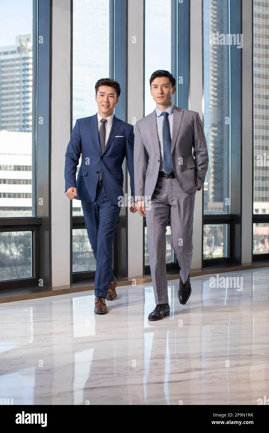 Successful businessmen walking Stock Photo - Alamy