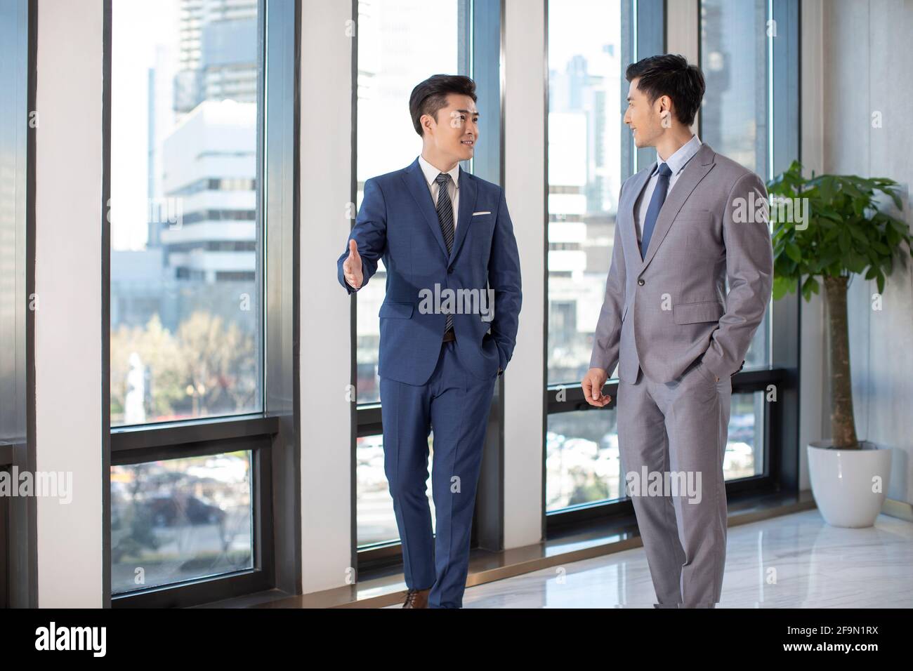 Successful businessmen talking Stock Photo - Alamy