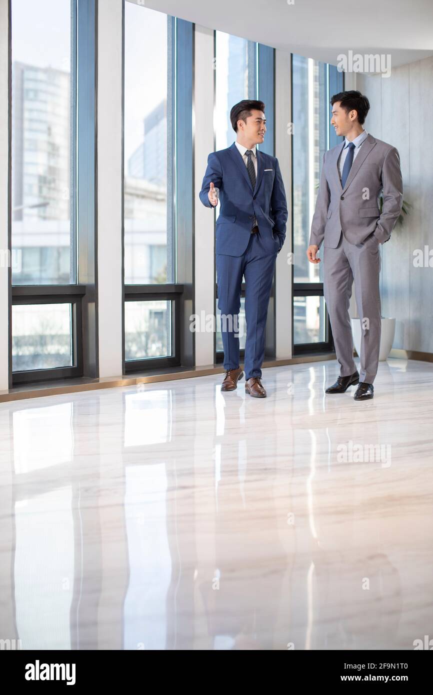 Successful businessmen talking Stock Photo - Alamy