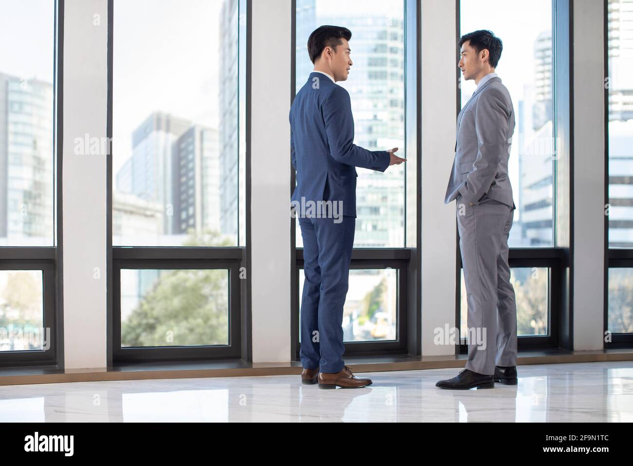 Successful businessmen talking Stock Photo - Alamy