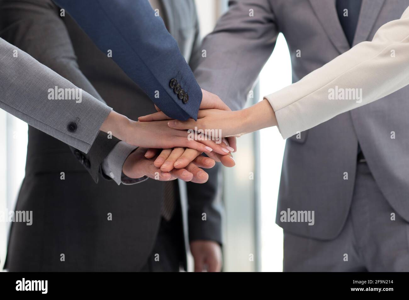 Successful business people stacking hands Stock Photo - Alamy