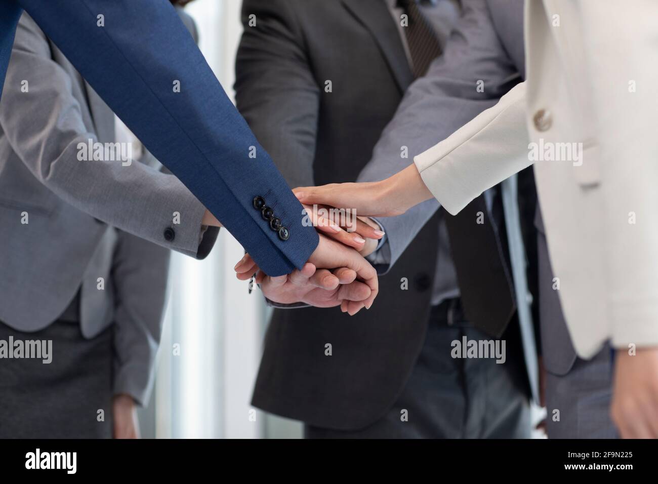 Successful business people stacking hands Stock Photo - Alamy