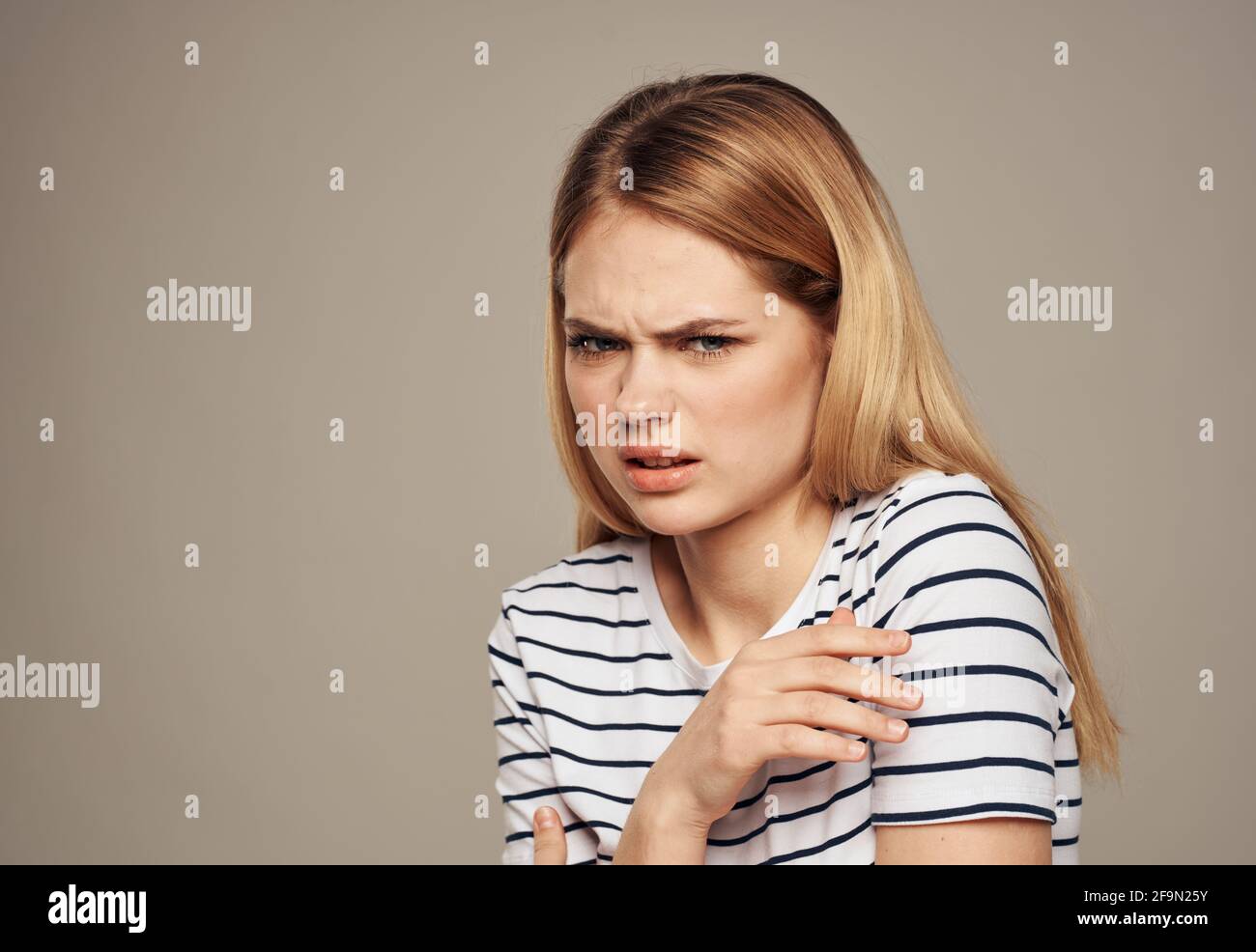 Upset woman model disgust emotions beige background portrait Stock ...