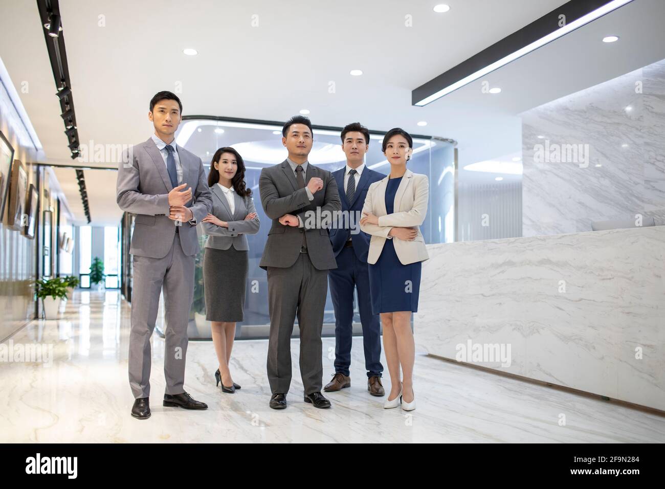 Business people standing in corridor 20 29 years hi-res stock ...