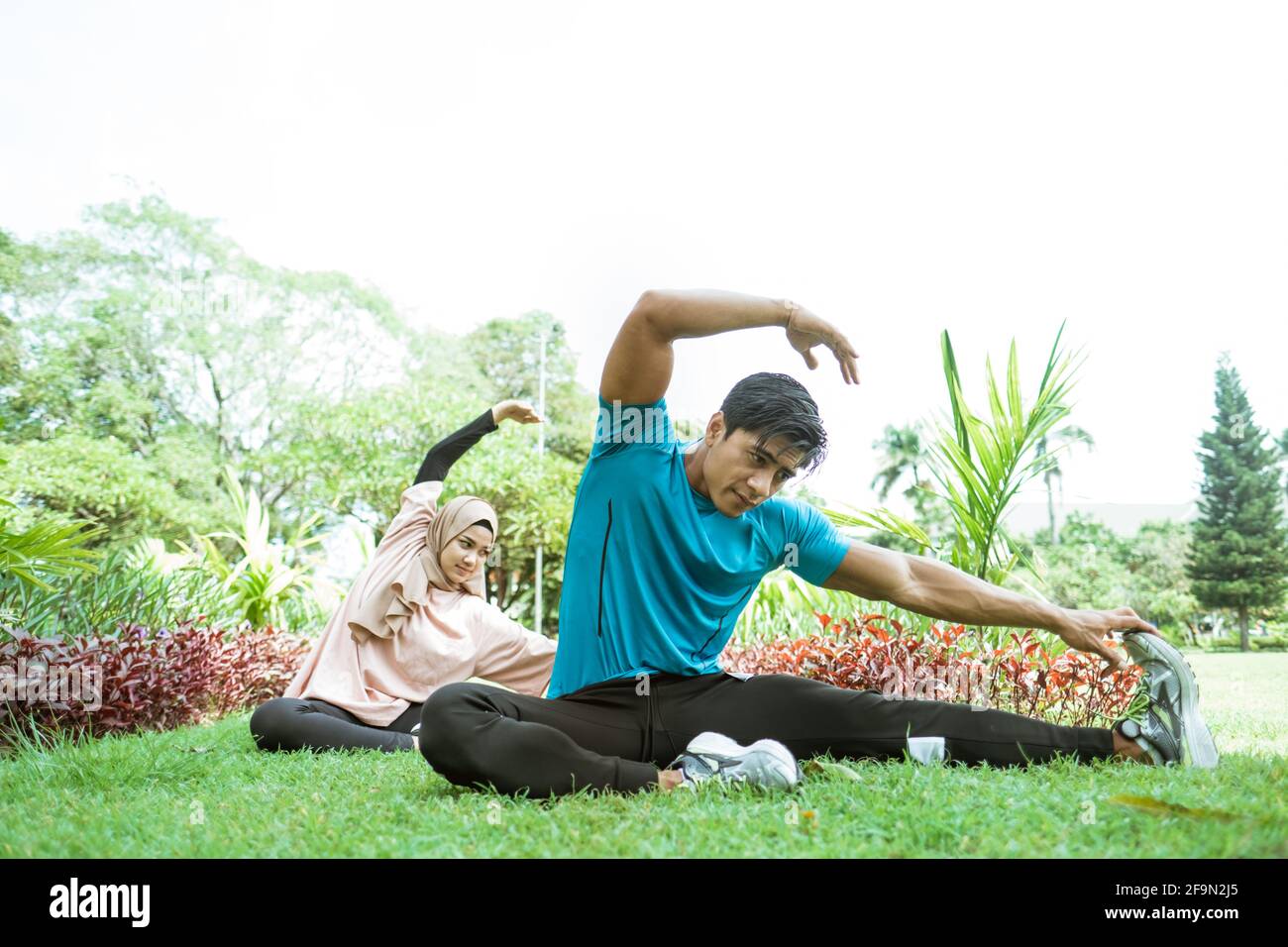 muslim couples doing movement to train leg muscles together when ...
