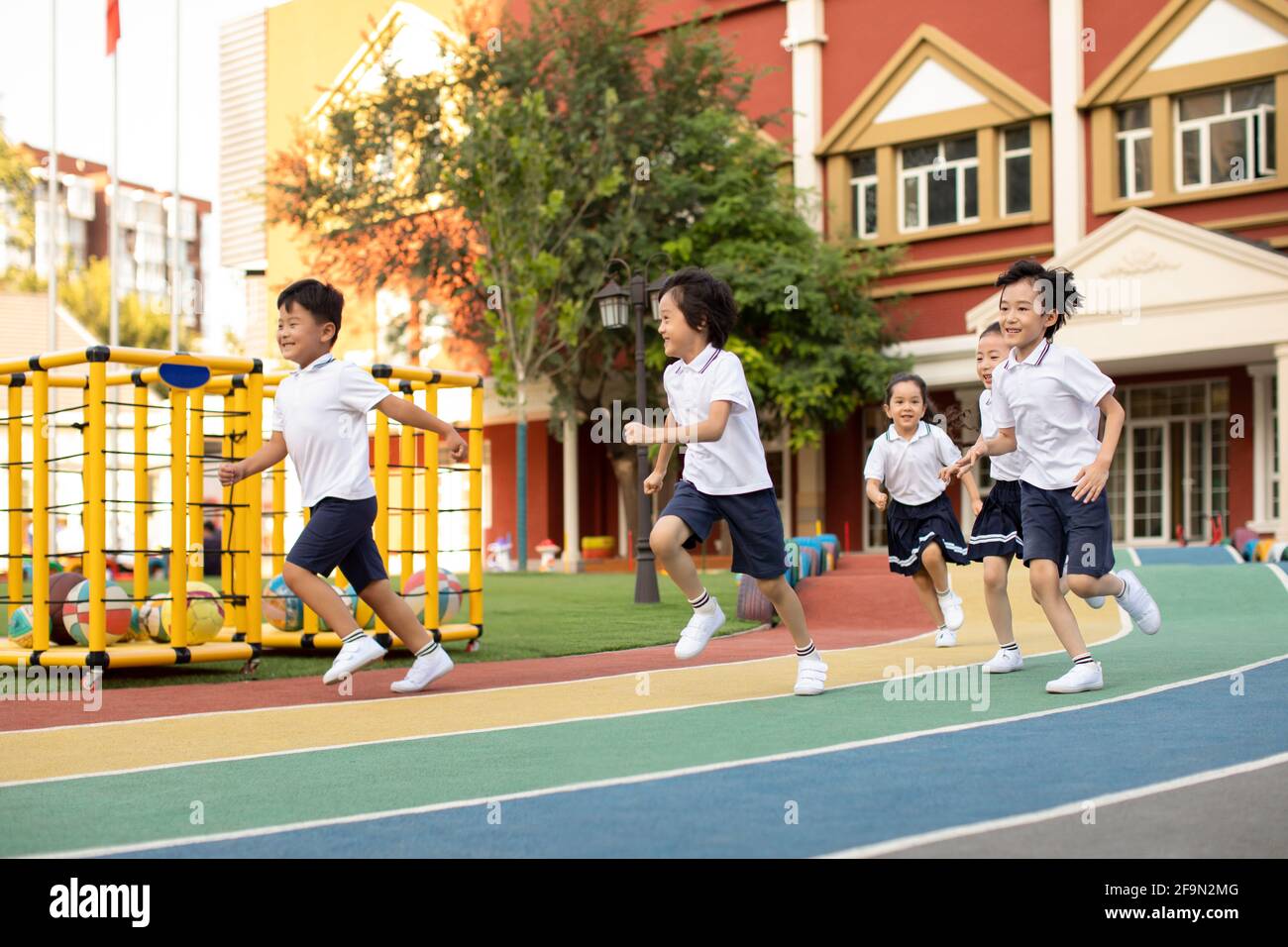 Children running on sports track Stock Photo - Alamy