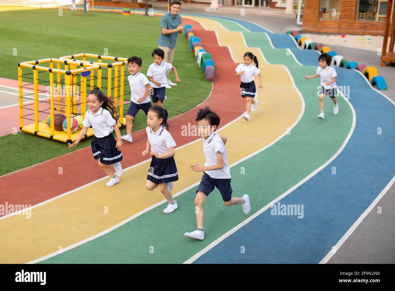 Children running on sports track Stock Photo - Alamy