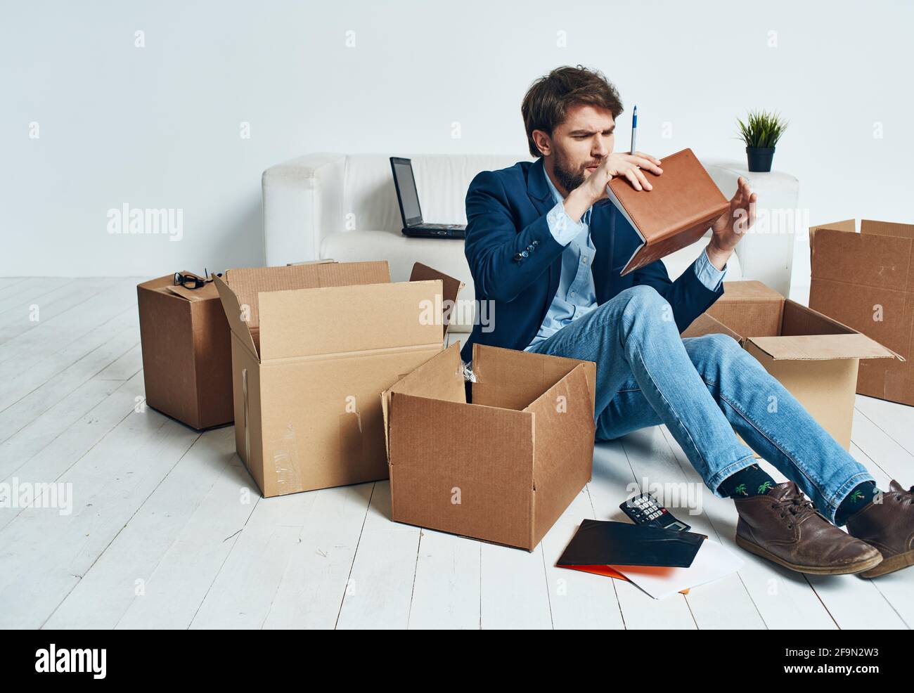 Man at home boxes with things moving work lifestyle Stock Photo - Alamy
