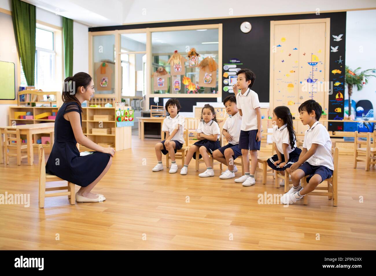 Teacher and children in classroom Stock Photo - Alamy