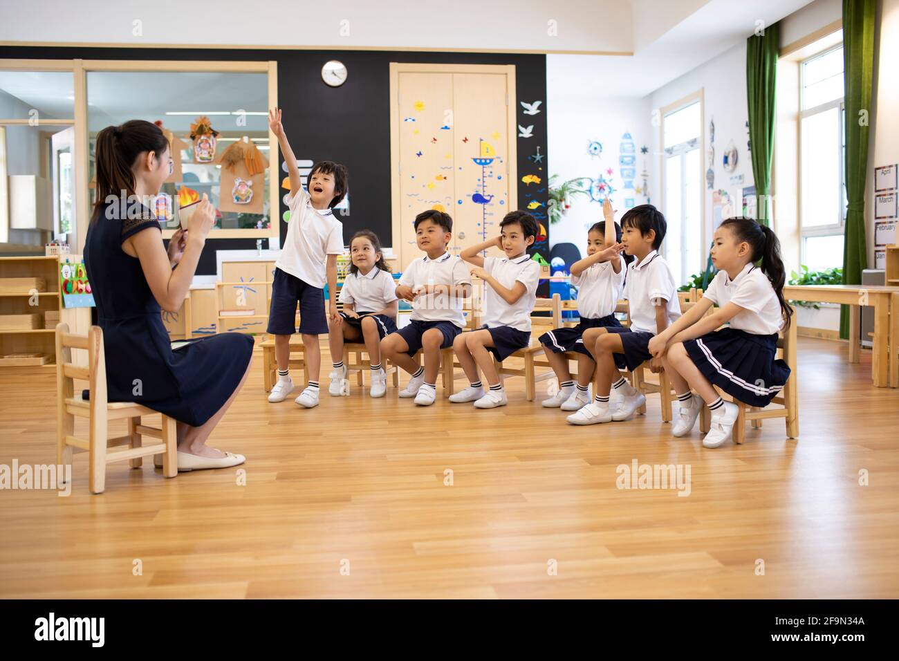 Teacher and children in classroom Stock Photo - Alamy
