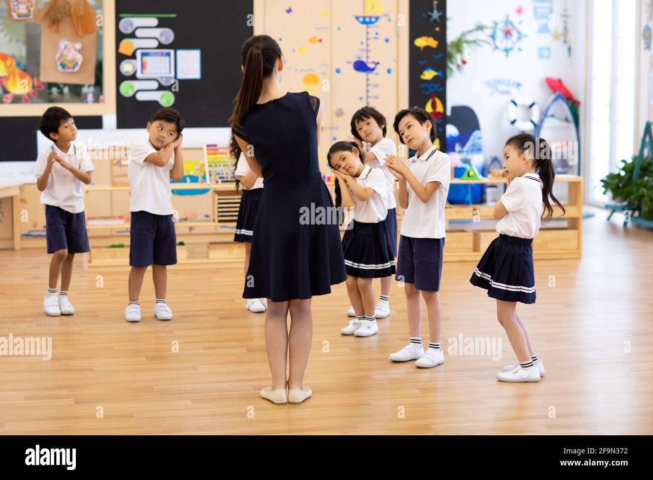 Teacher teaching children dancing in classroom Stock Photo - Alamy