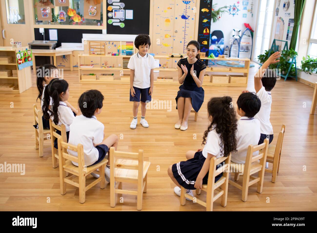 Teacher and children in classroom Stock Photo - Alamy
