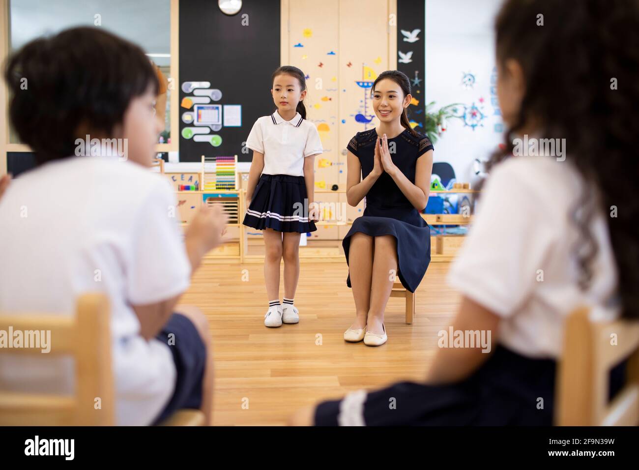 Teacher and children in classroom Stock Photo - Alamy
