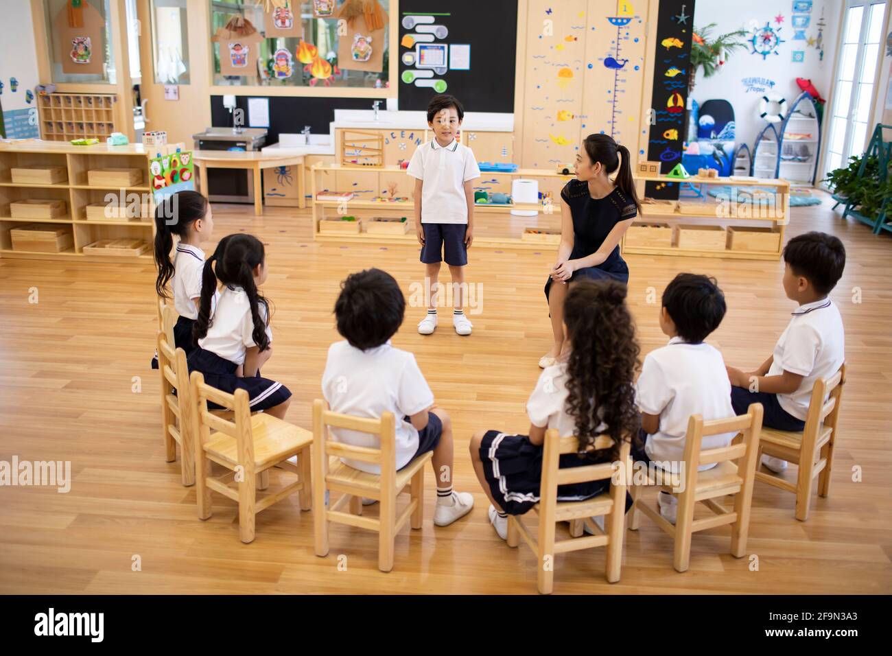 Teacher and children in classroom Stock Photo - Alamy