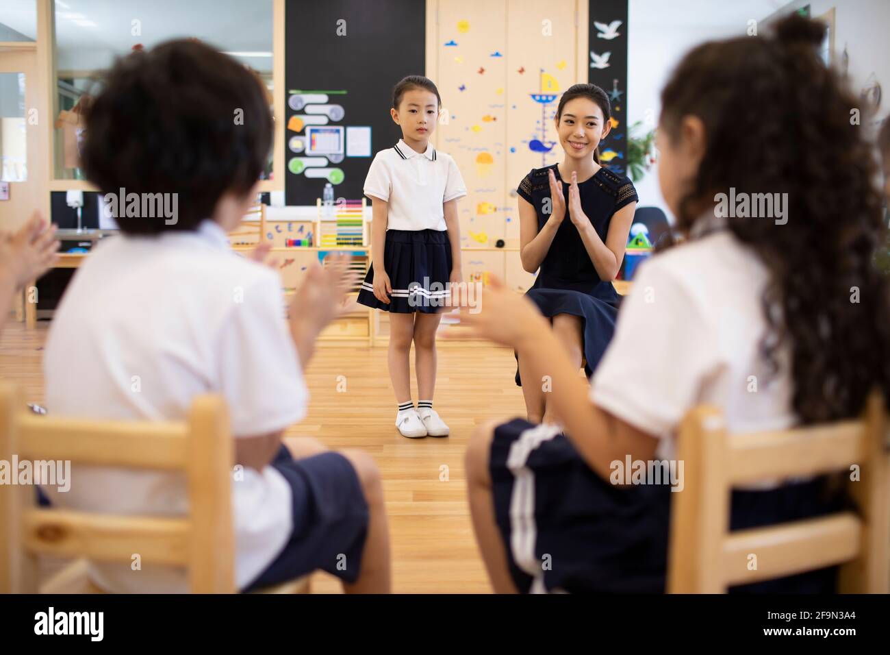 Teacher and children in classroom Stock Photo - Alamy