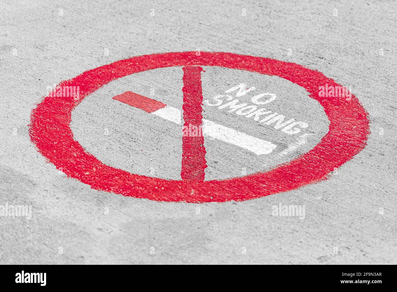 No smoking sign with a crossed out cigarette in a red circle painted on ...