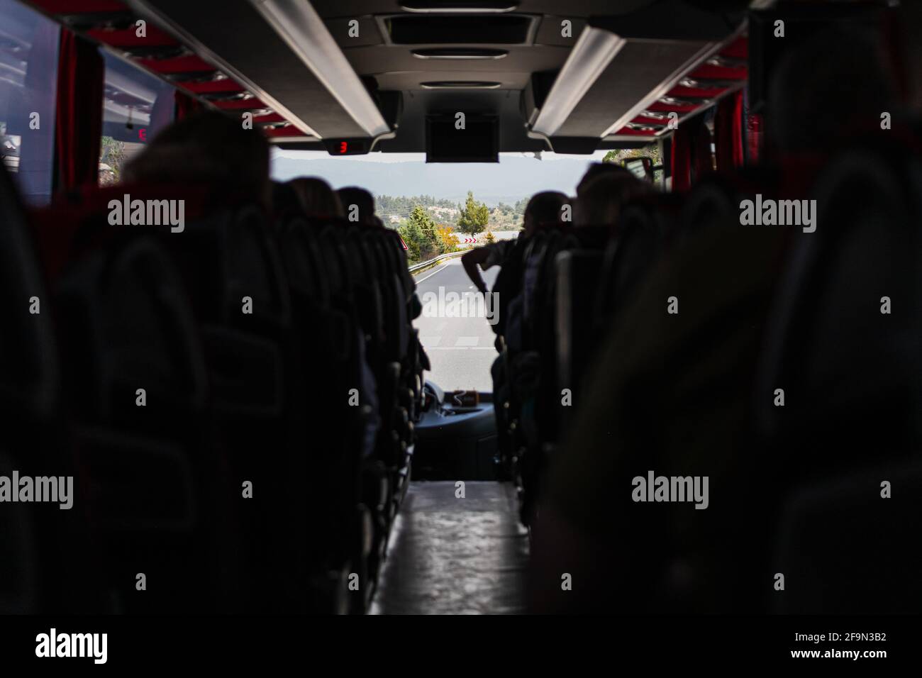 A full bus of tourist passengers traveling on the motorway at a resort ...