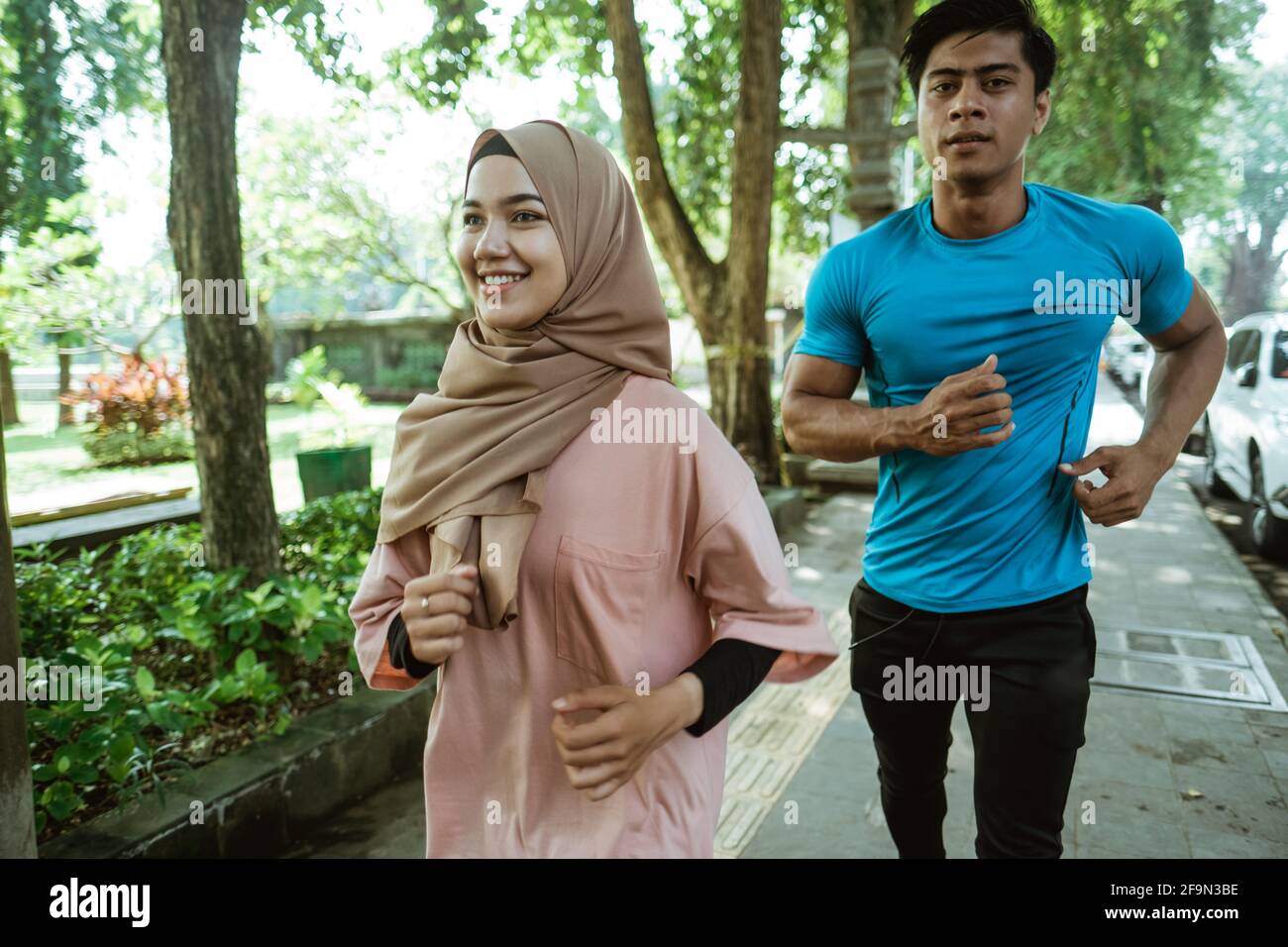 muslim couples doing jogging together when outdoor exercise Stock Photo ...