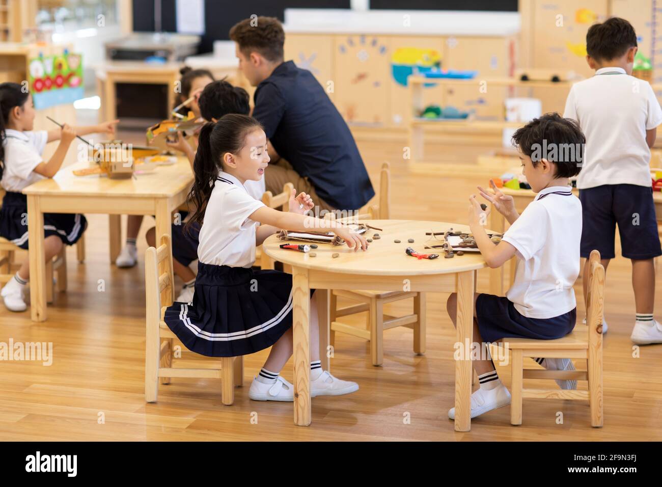 Foreign teacher teaching art class in classroom Stock Photo - Alamy