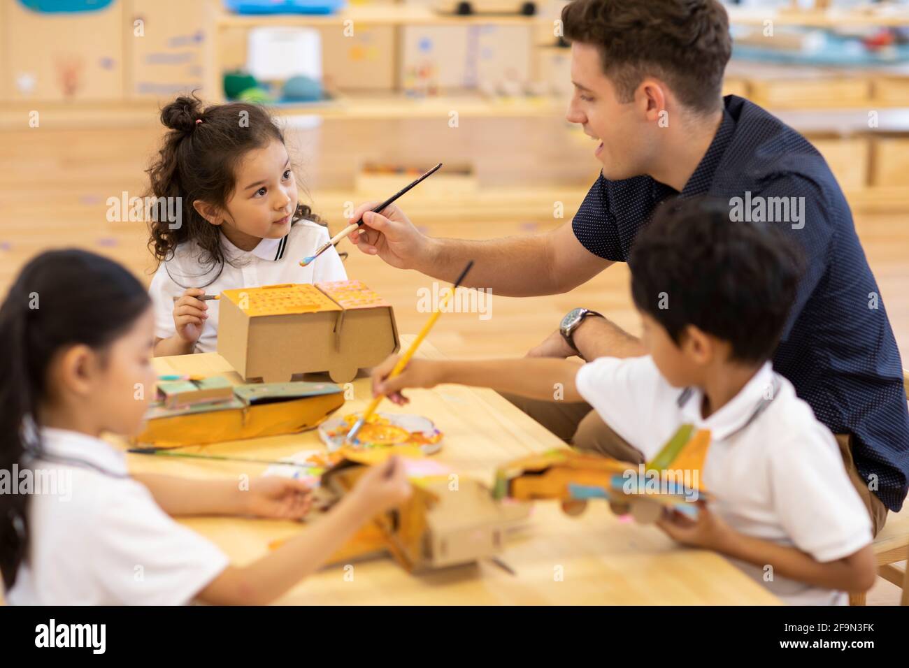 Foreign teacher teaching art class in classroom Stock Photo - Alamy