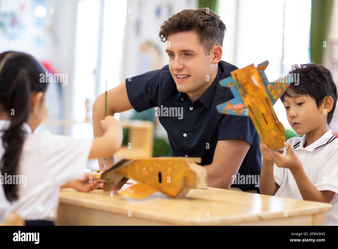 Foreign teacher teaching art class in classroom Stock Photo - Alamy