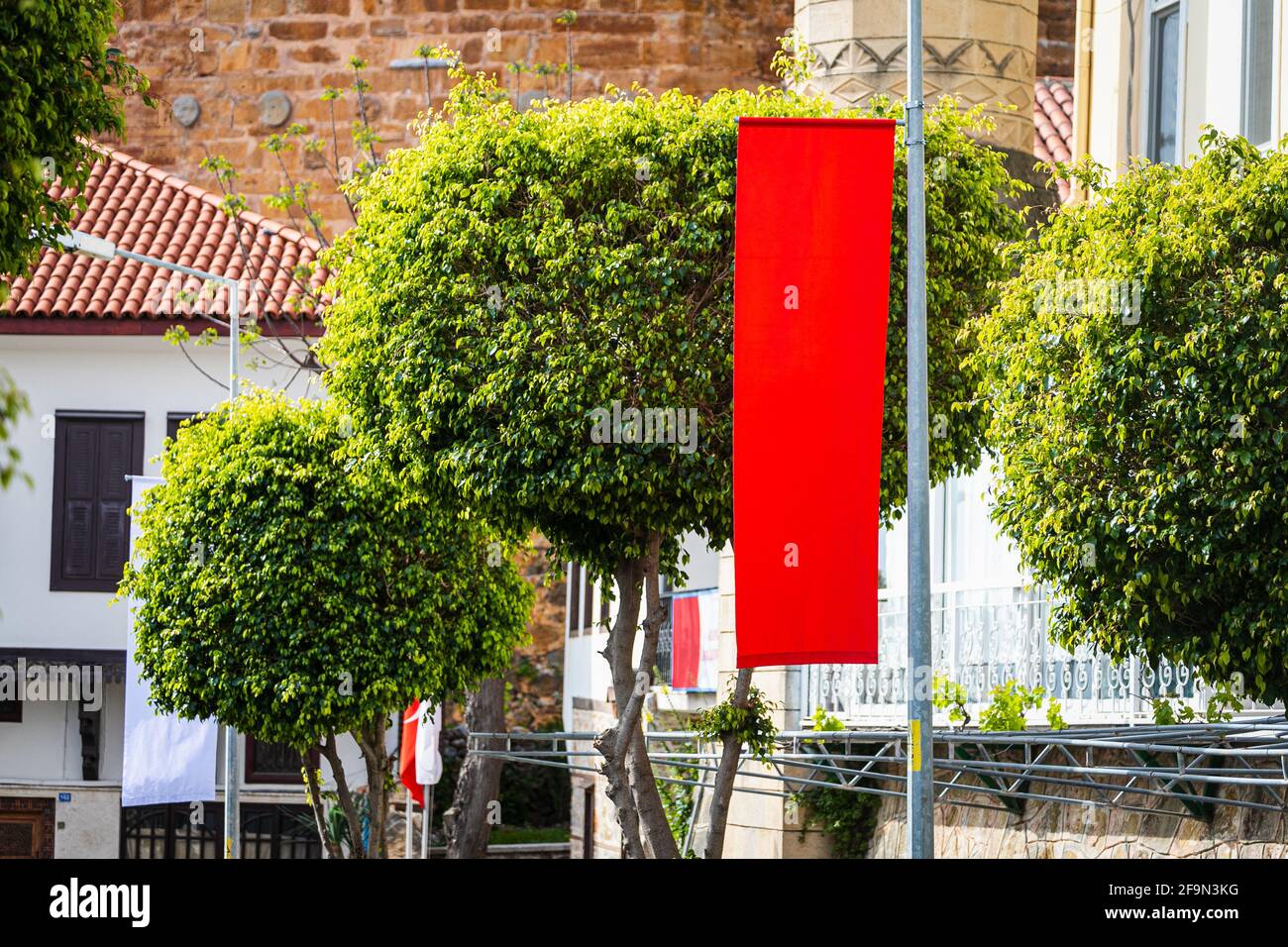 Bright red flag for design against the background of beautiful trimmed ...