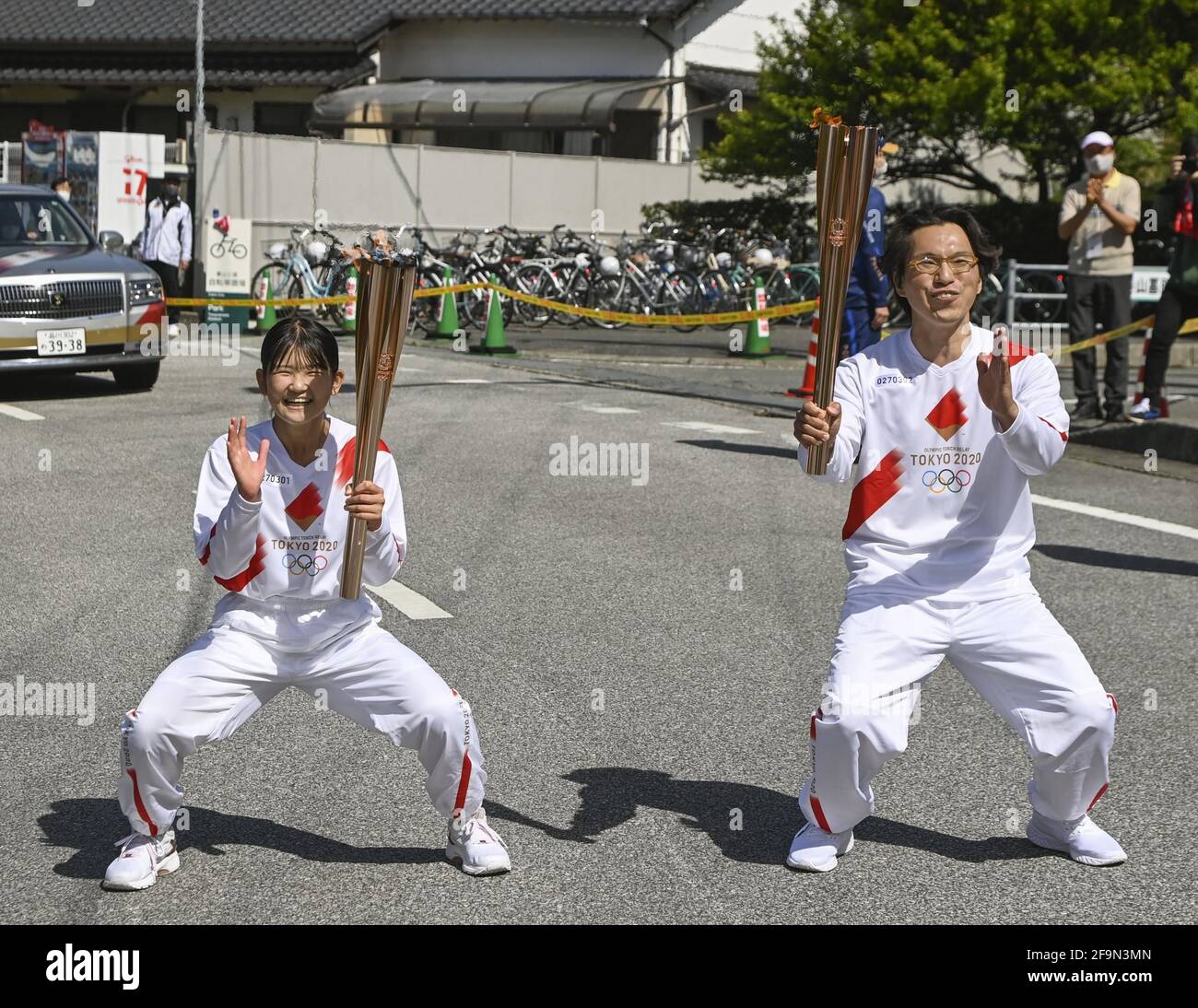 Tokyo Olympic torch runners pose after handing over the Olympic flame ...