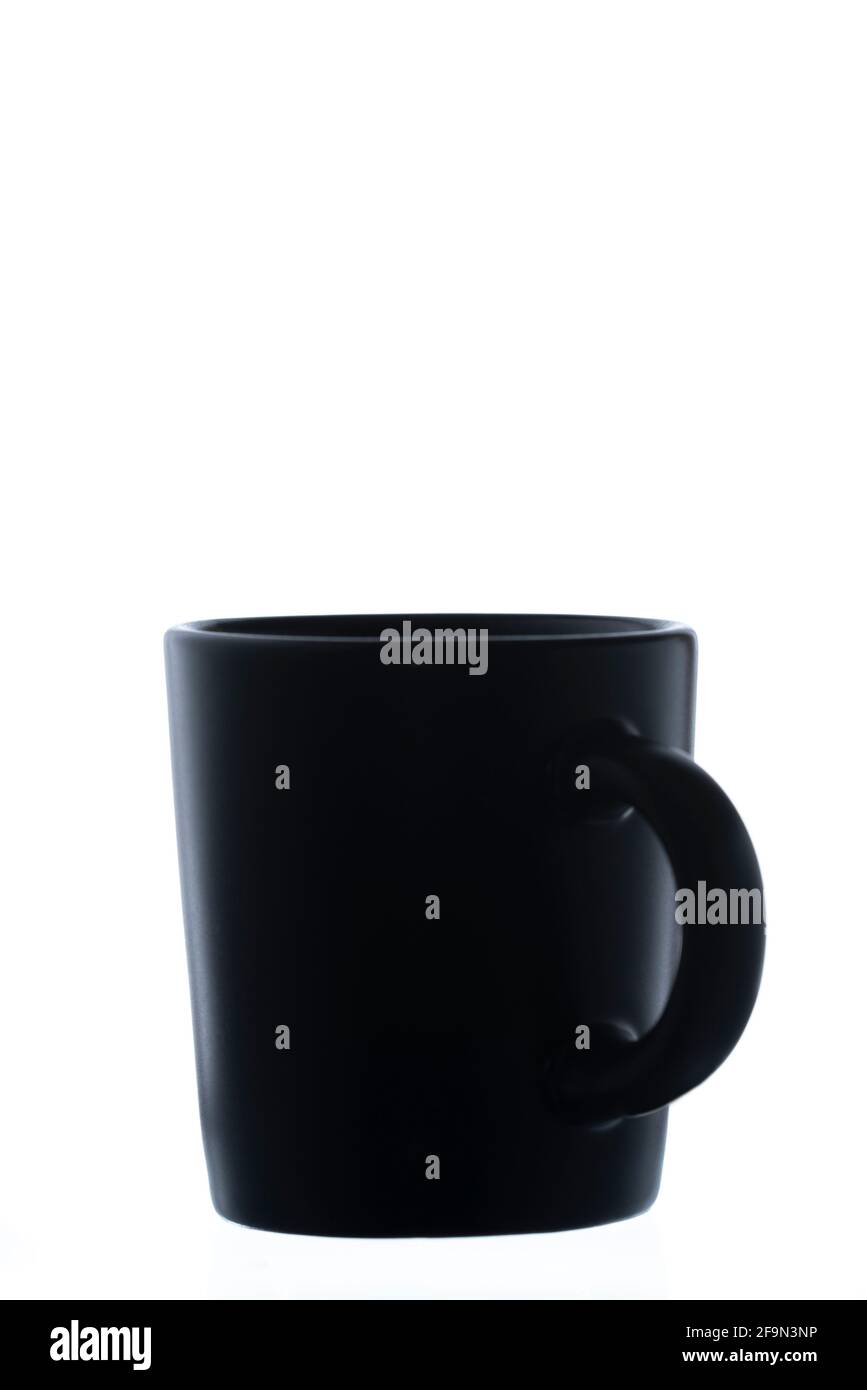 Single black Mug in vertical position, with the handle in an angle to ...