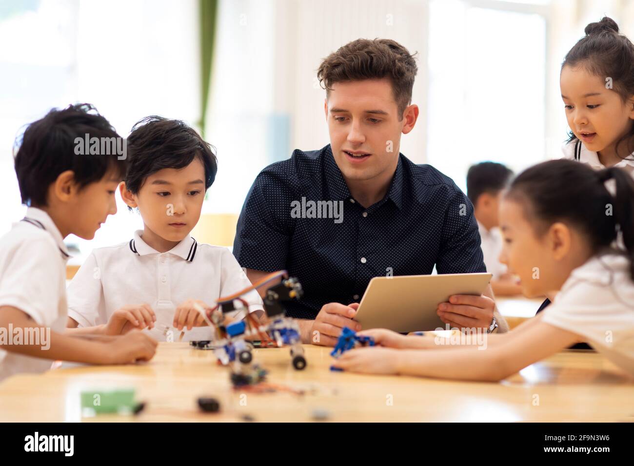 Children learning coding in classroom Stock Photo - Alamy