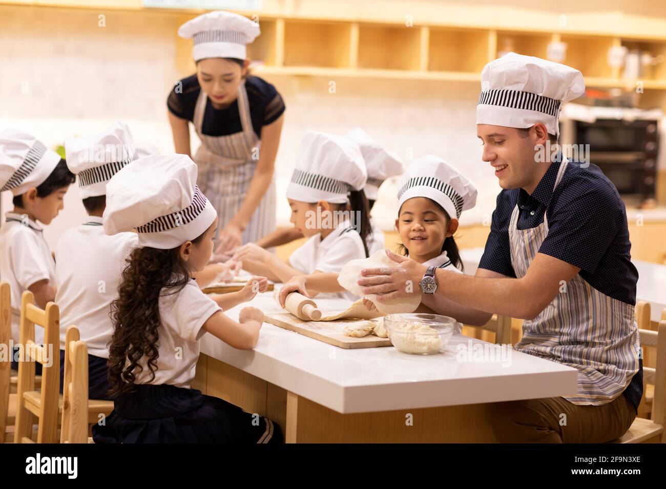 Children learning cooking in classroom Stock Photo - Alamy
