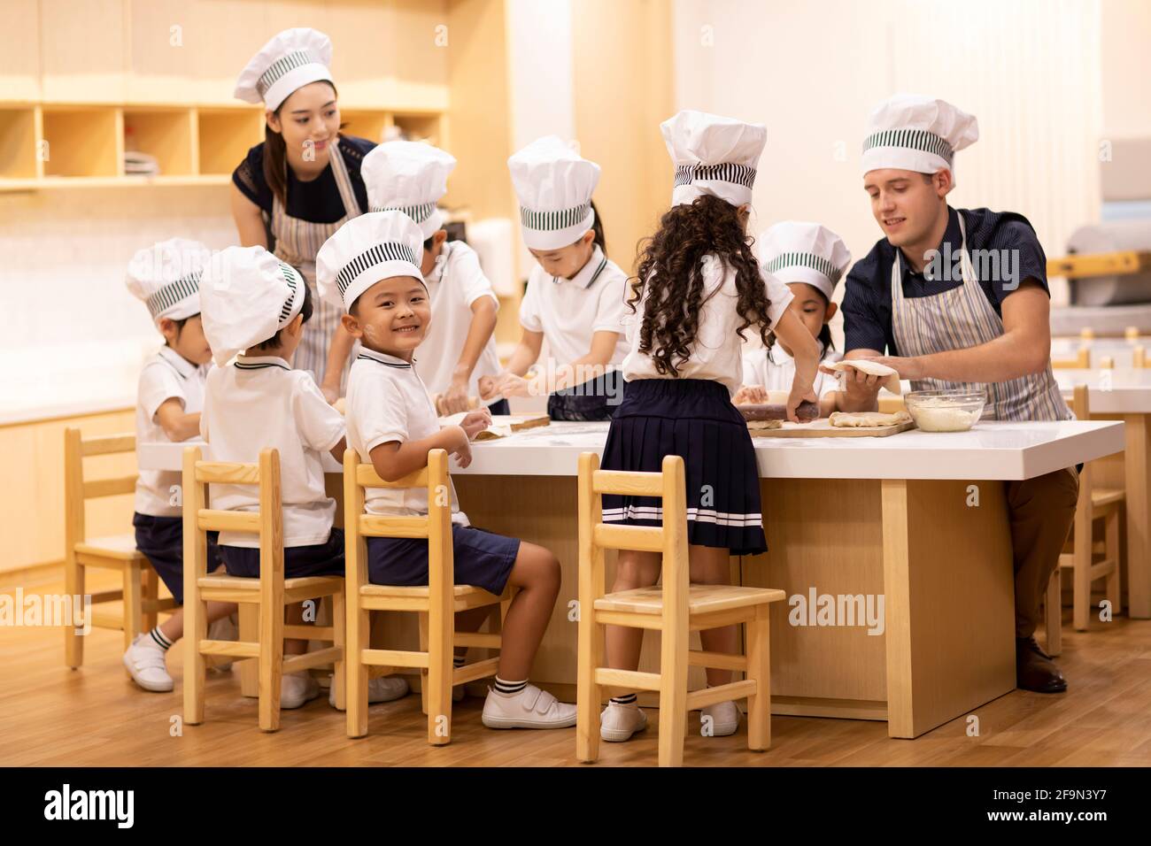 Children learning cooking in classroom Stock Photo - Alamy